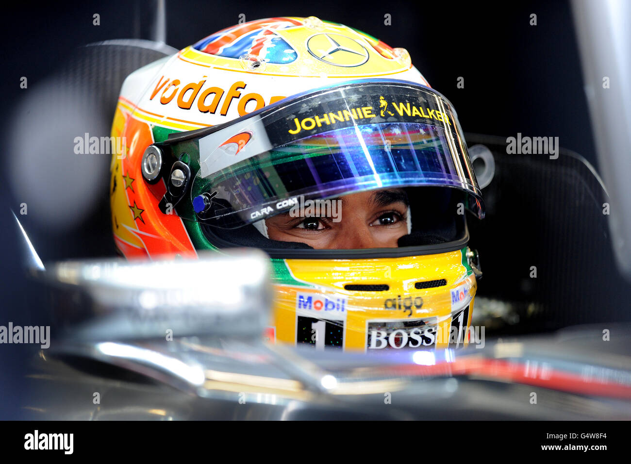 McLaren Mercedes' Lewis Hamilton in his car in the team garage during ...