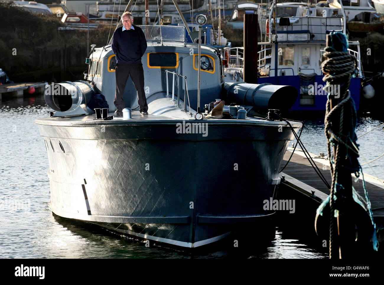 Richard Basey stands on the deck of Motor Torpedo Boat 102, tied up at ...