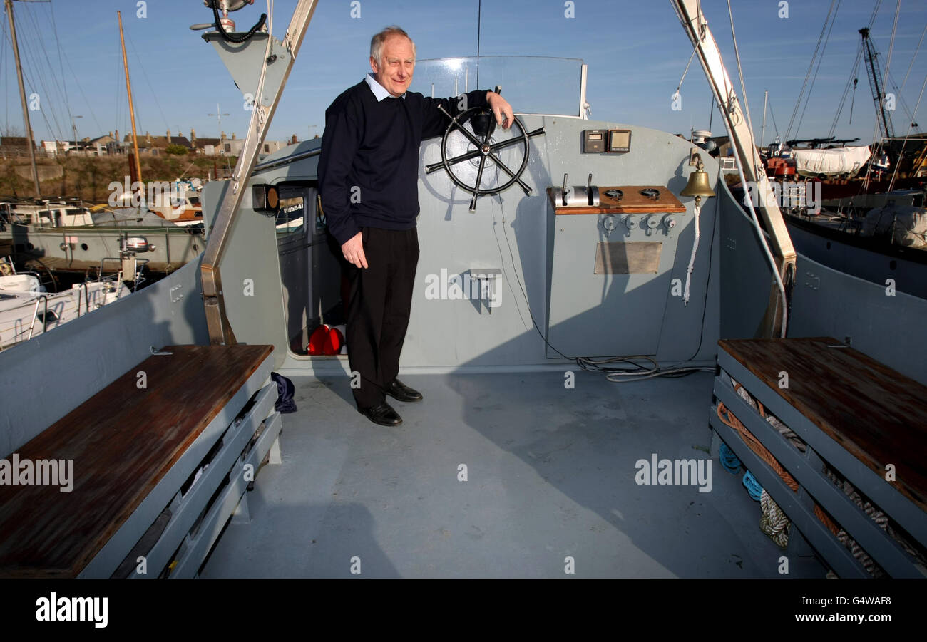 Richard Basey stands on the deck of Motor Torpedo Boat 102, tied up at ...