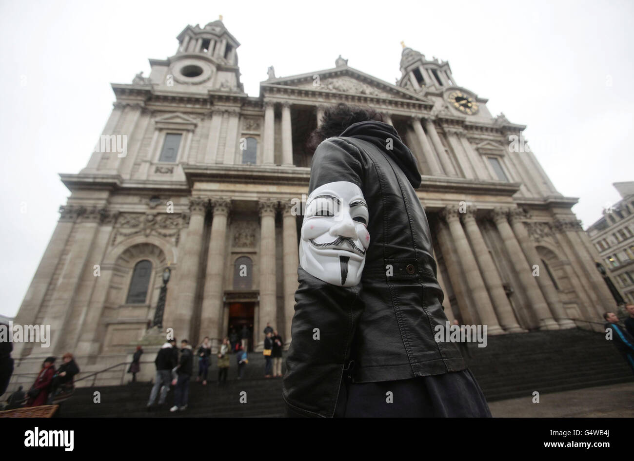 A protester wearing a mask on his arm at the Occupy London site outside ...