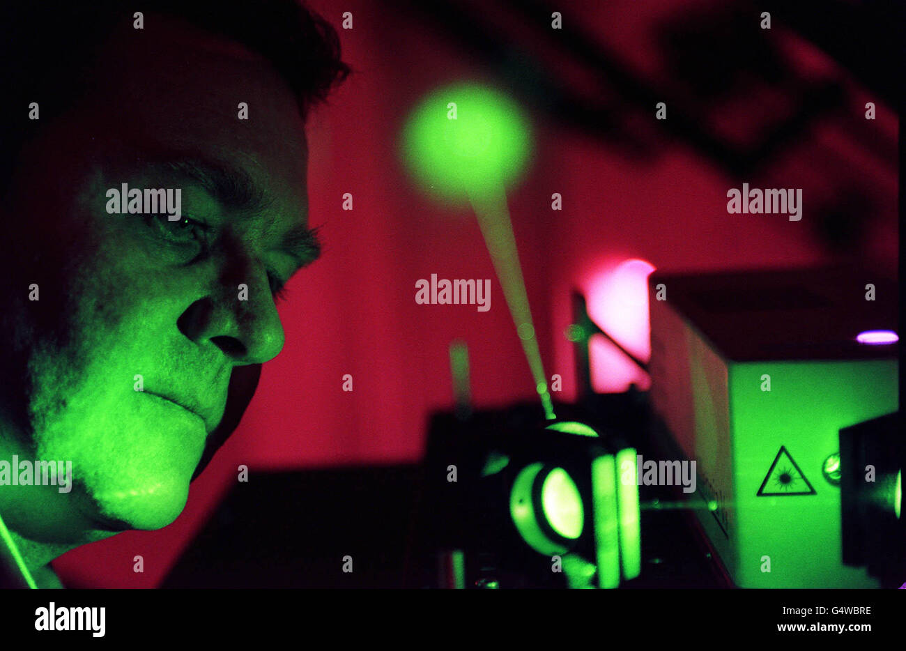 Laser expert Bob Brien operates a green laser, which extends from the ...