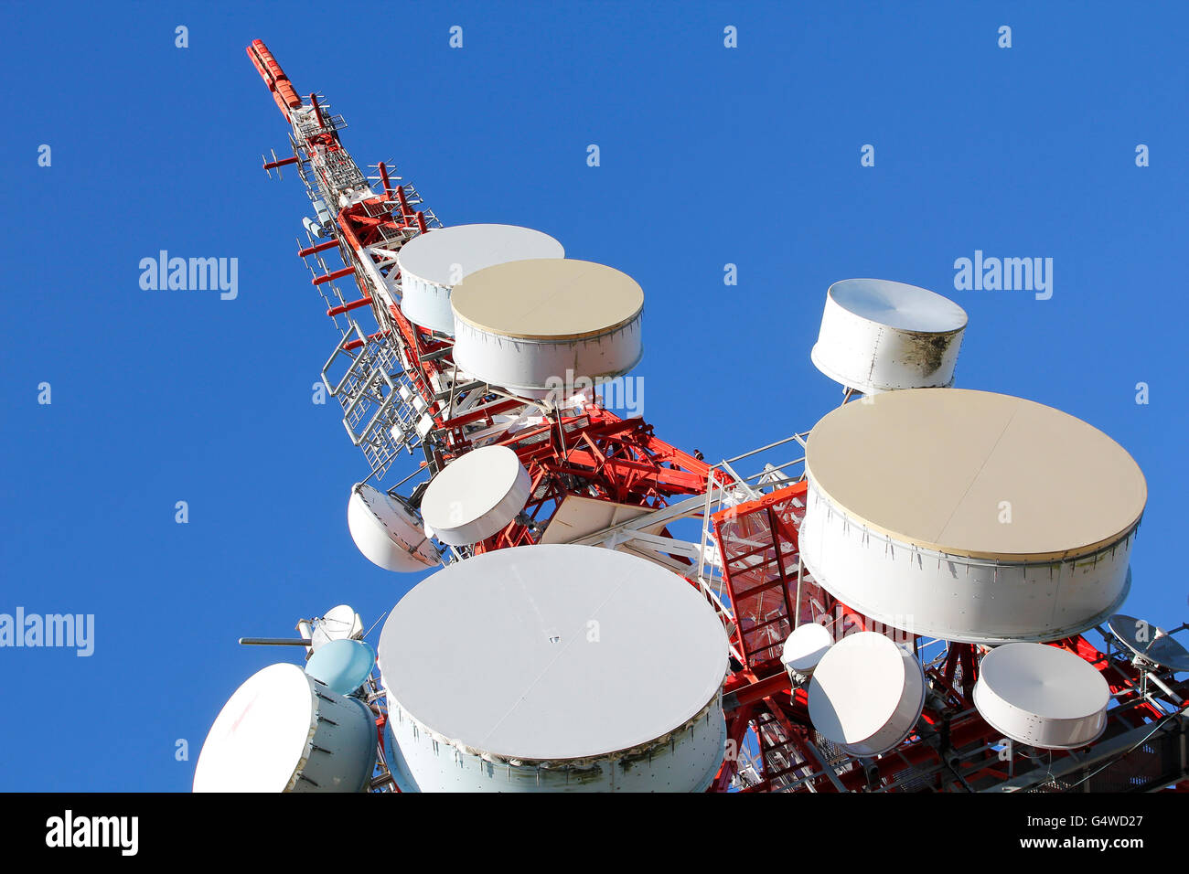 Telecommunications tower against blue sky Stock Photo - Alamy