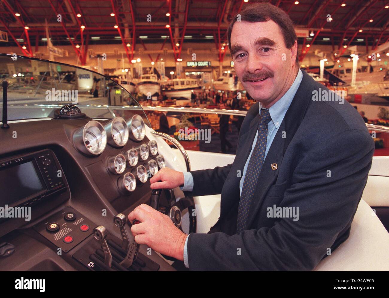 Former world champion racing driver, Nigel Mansell sits aboard a ...