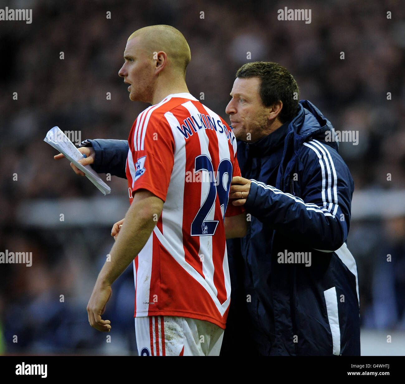 Stoke City's Andy Wilkinson (left) is given directions by first team ...