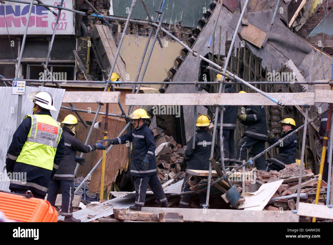 Firefighters search through the rubble of collapsed building in bootle ...