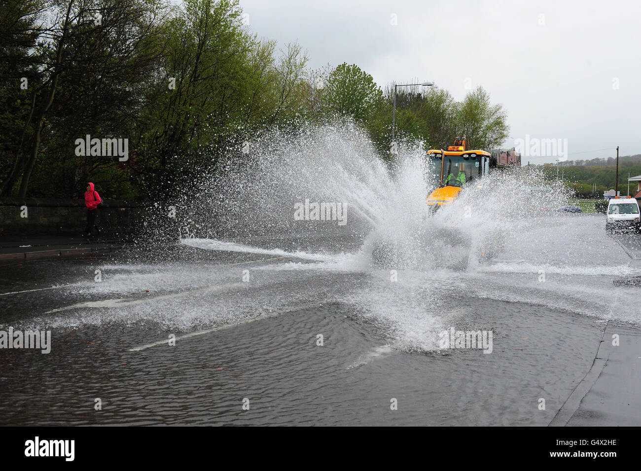 A JCB tries to control the flow of a burst water main in Gateshead ...
