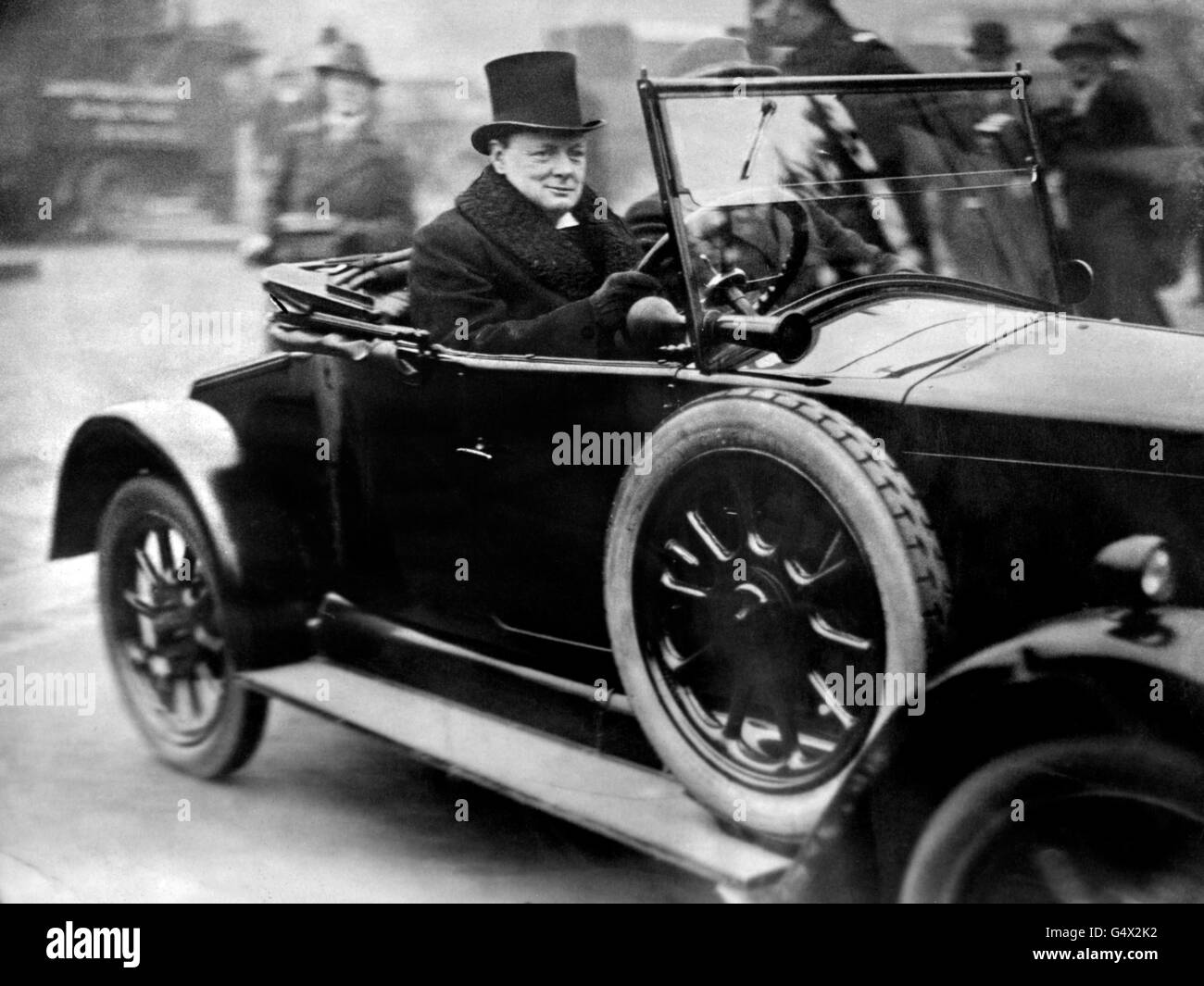 Chancellor of the Exchequer Winston Churchill arrives in a two seater ...