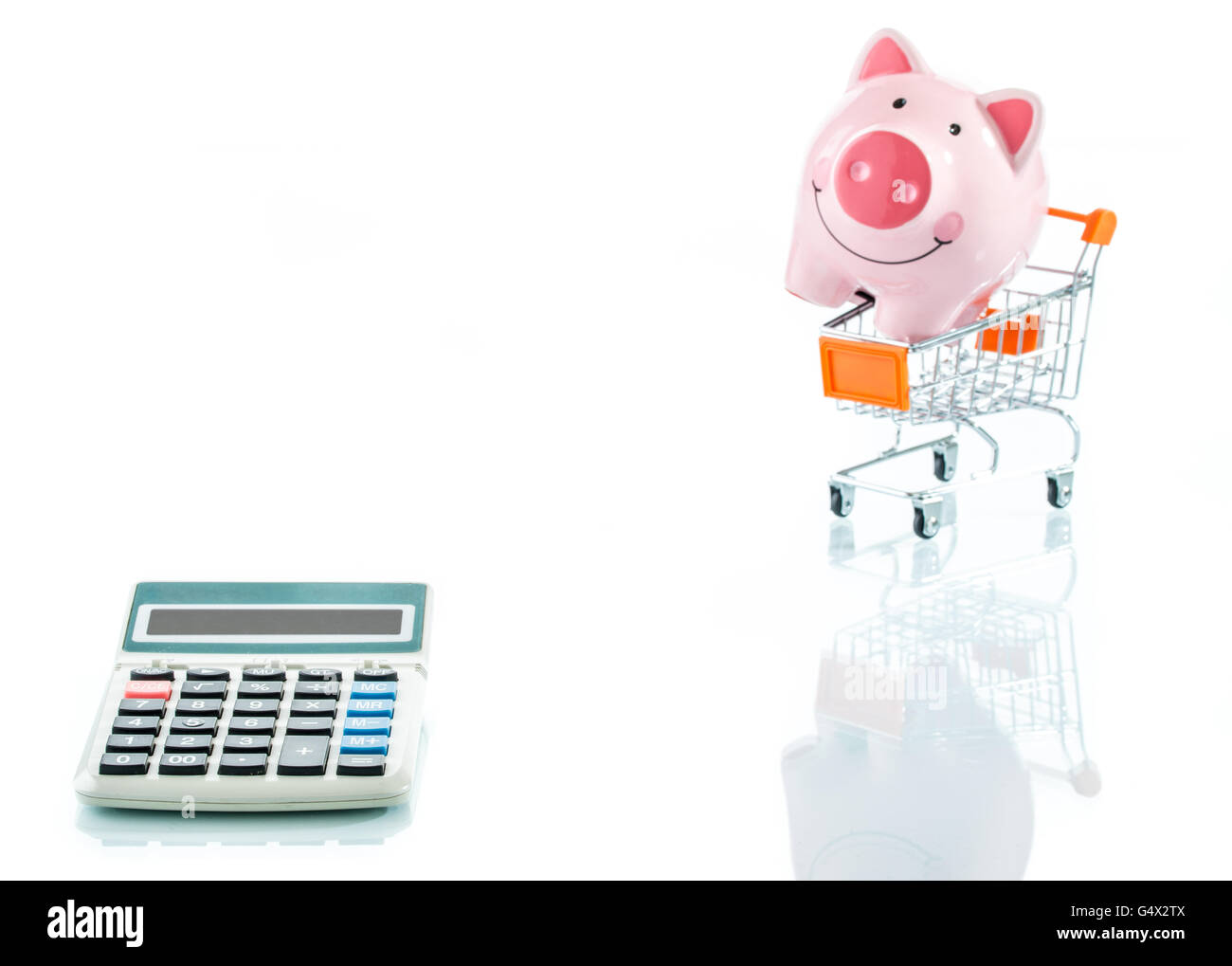 Piggy bank, calculator and a shopping trolley isolated on white Stock ...