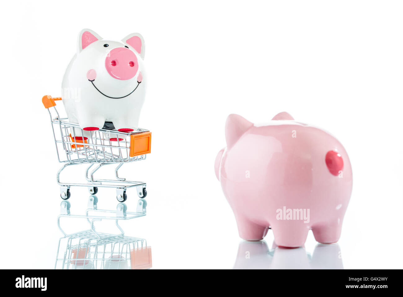 Piggy bank in a shopping trolley isolated on white background Stock ...