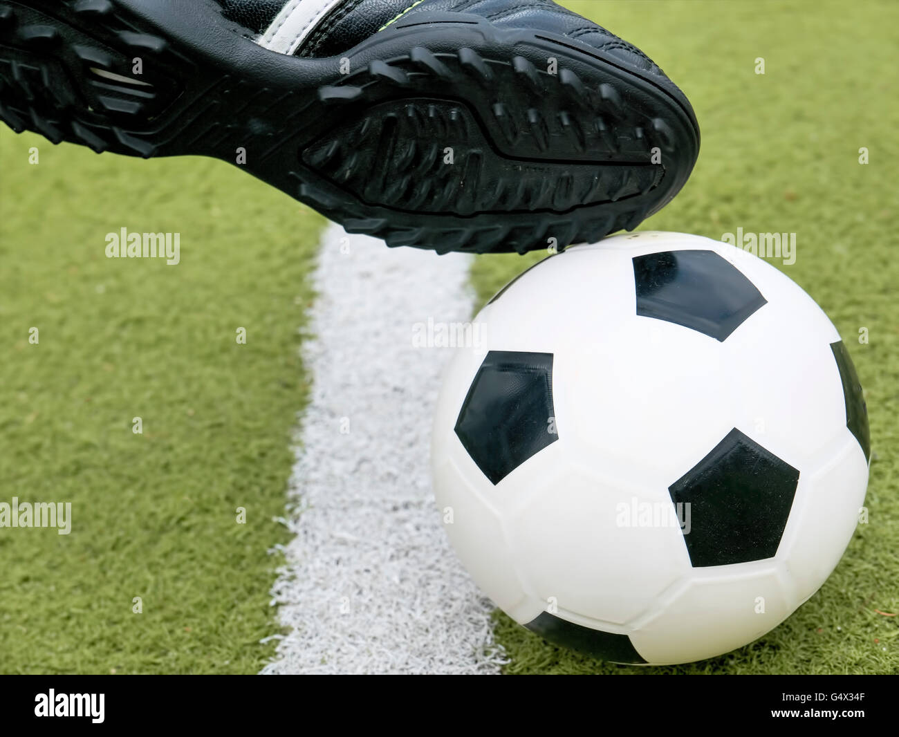 Soccer player doing kick with ball on football stadium field Stock ...