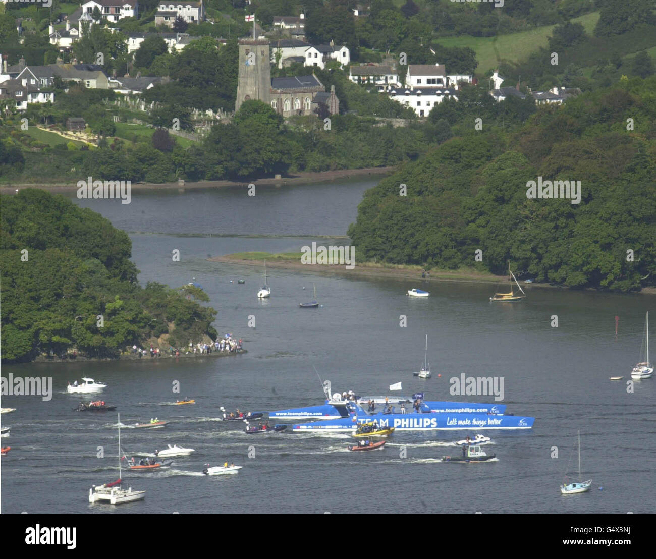 Flotilla of small boats follows the 4 million catamaran "Team Philips ...