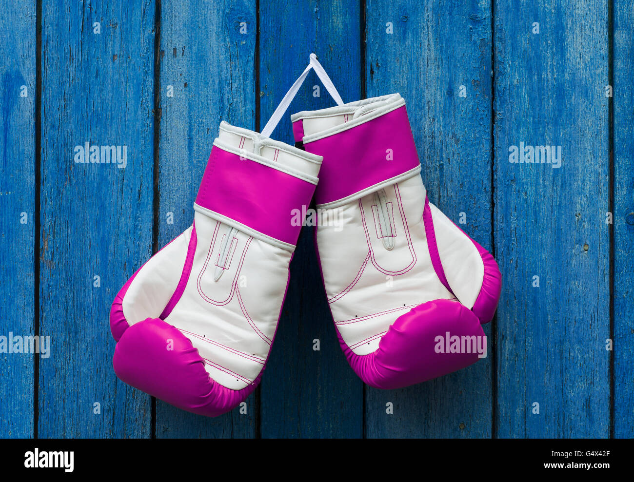 Blue leather hanging boxing gloves hi-res stock photography and images ...
