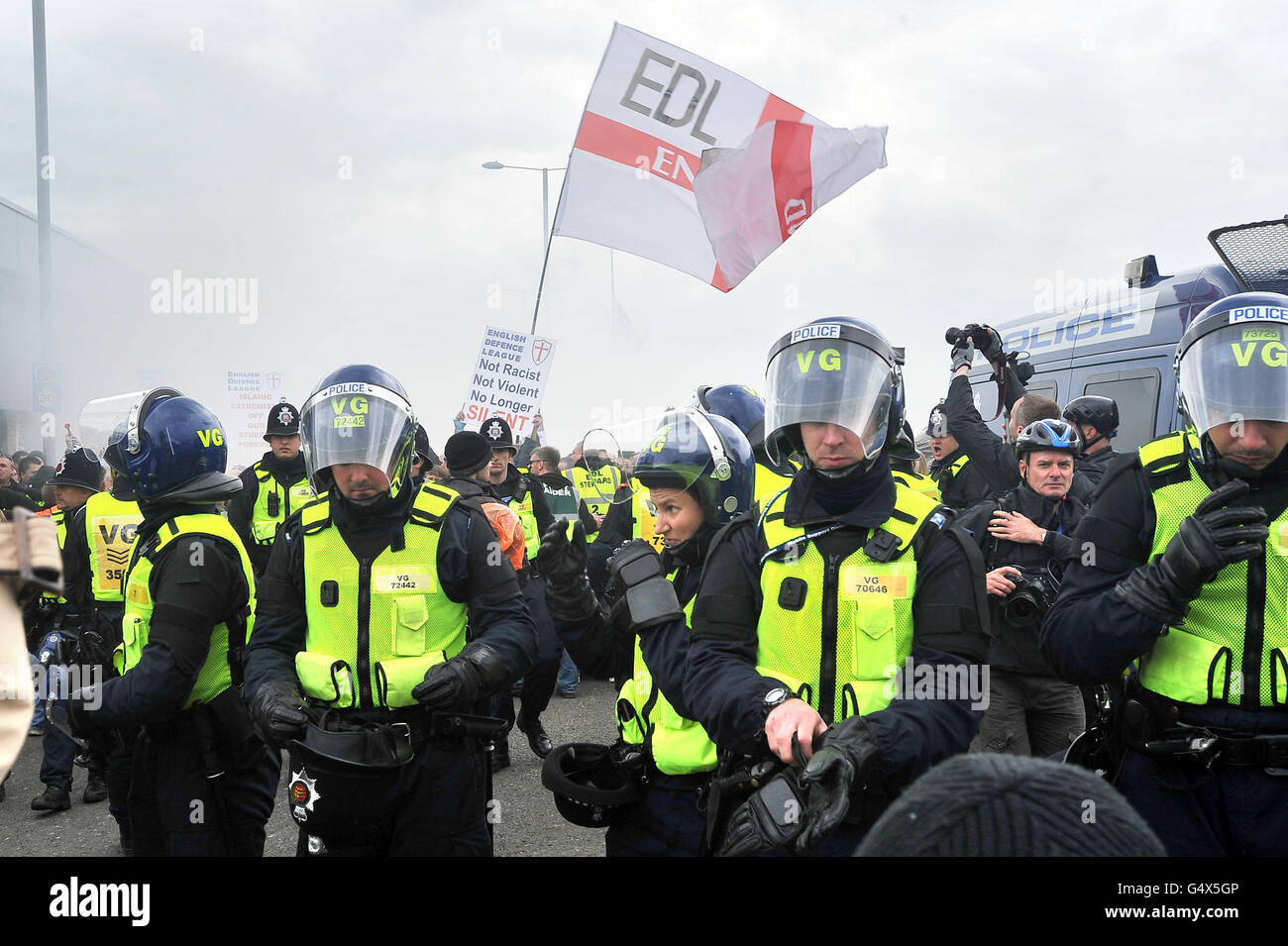A smoke grenade explodes as EDL supporters march in central Luton while ...