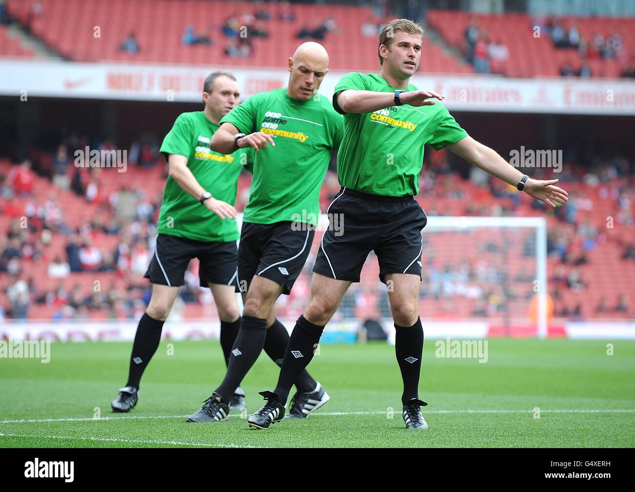 Match referee Howard Webb (centre) warms up with his fellow officials ...
