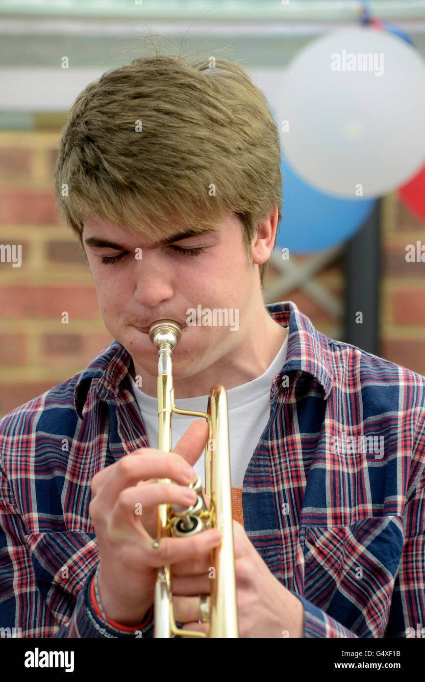 Teenage trumpeter performing with his band at local street party Stock ...