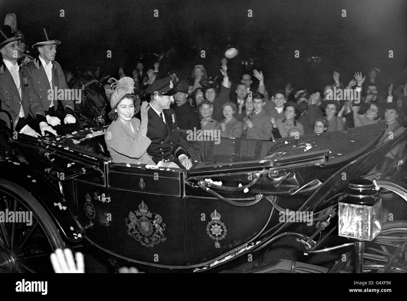 Princess Elizabeth and the Duke of Edinburgh in a carriage procession ...