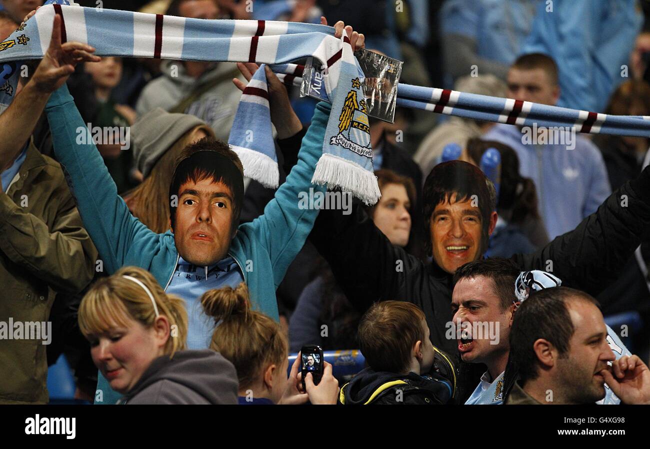 Two Manchester City fans wearing Liam and Noel Gallagher masks ...