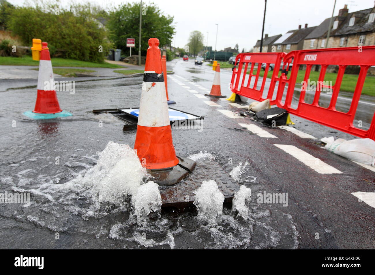 A man hole cover is burst open by excess water in Witney, Oxfordshire ...