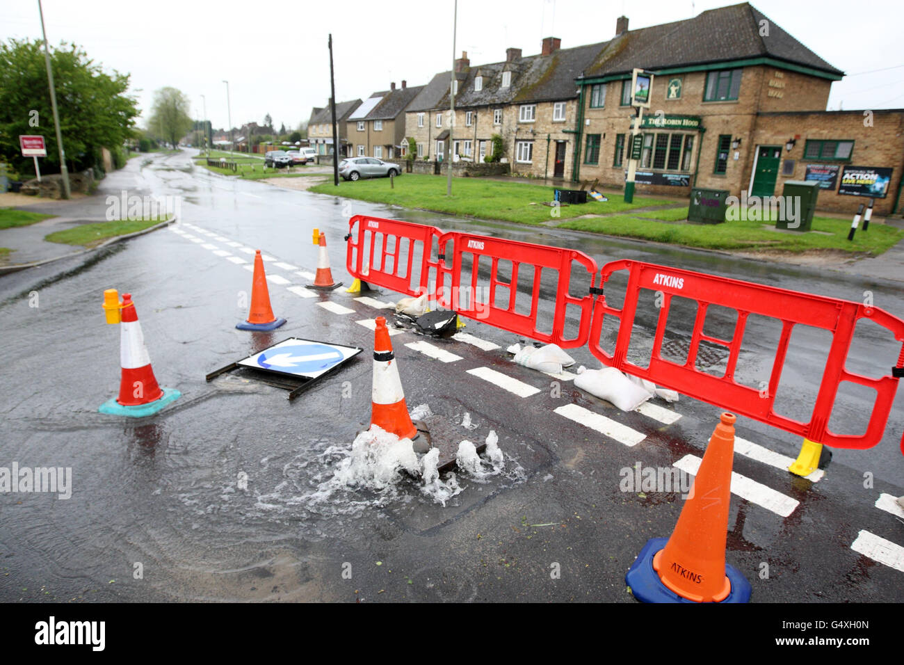 A man hole cover is burst open by excess water in Witney, Oxfordshire ...