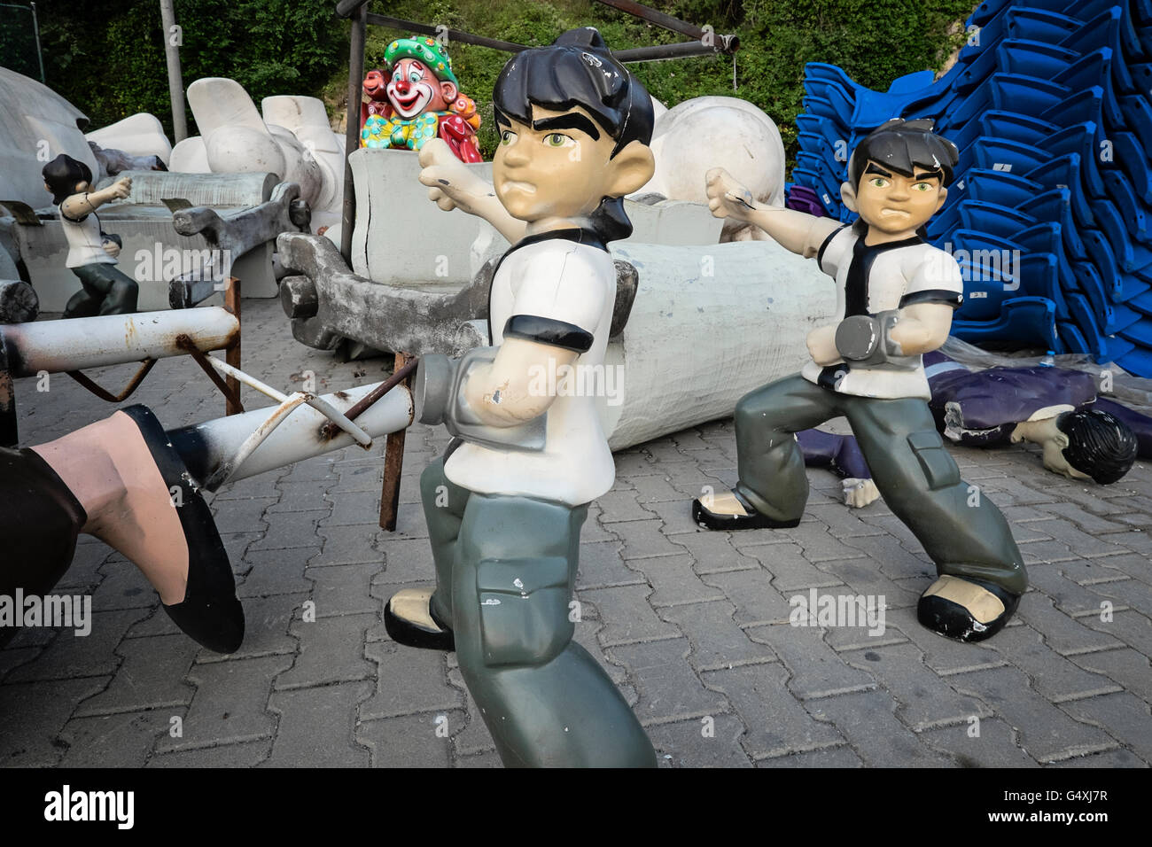 A junk yard for broken cartoon characters from fairgrounds and ...