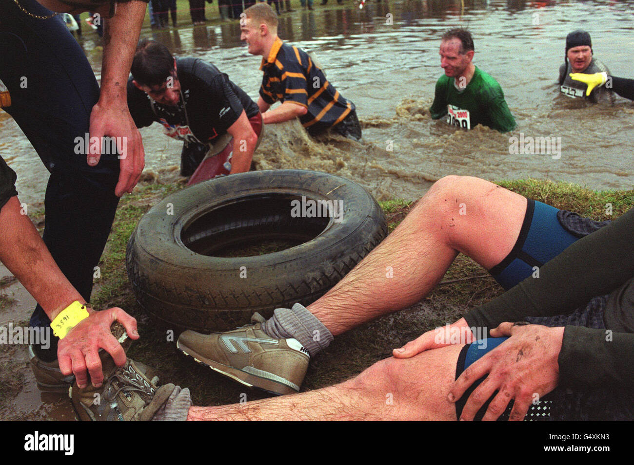 A competitor suffers from cramp whilst taking part in the Tough Guy ...