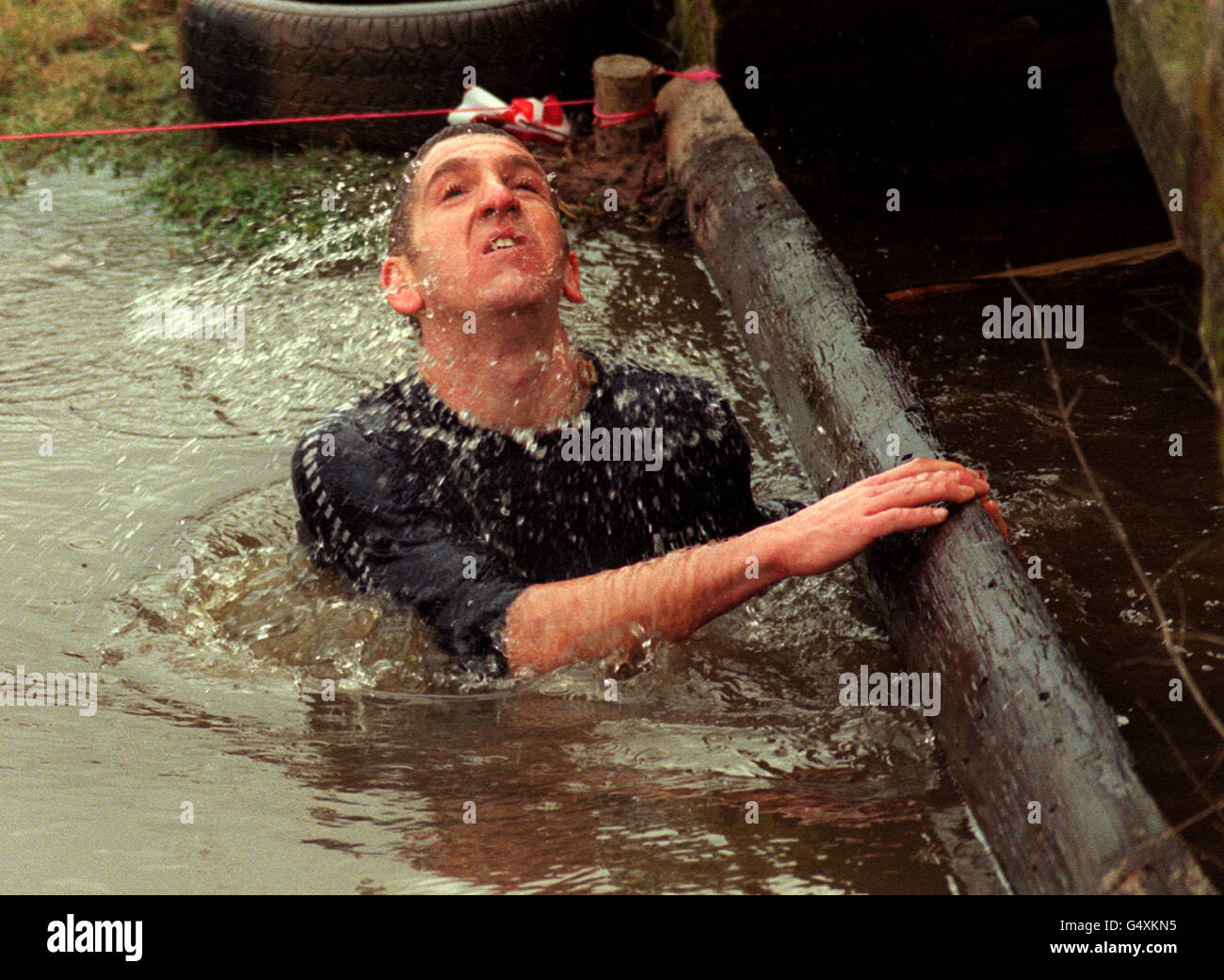 A competitor taking part in the Tough Guy 2000 endurance race for ...