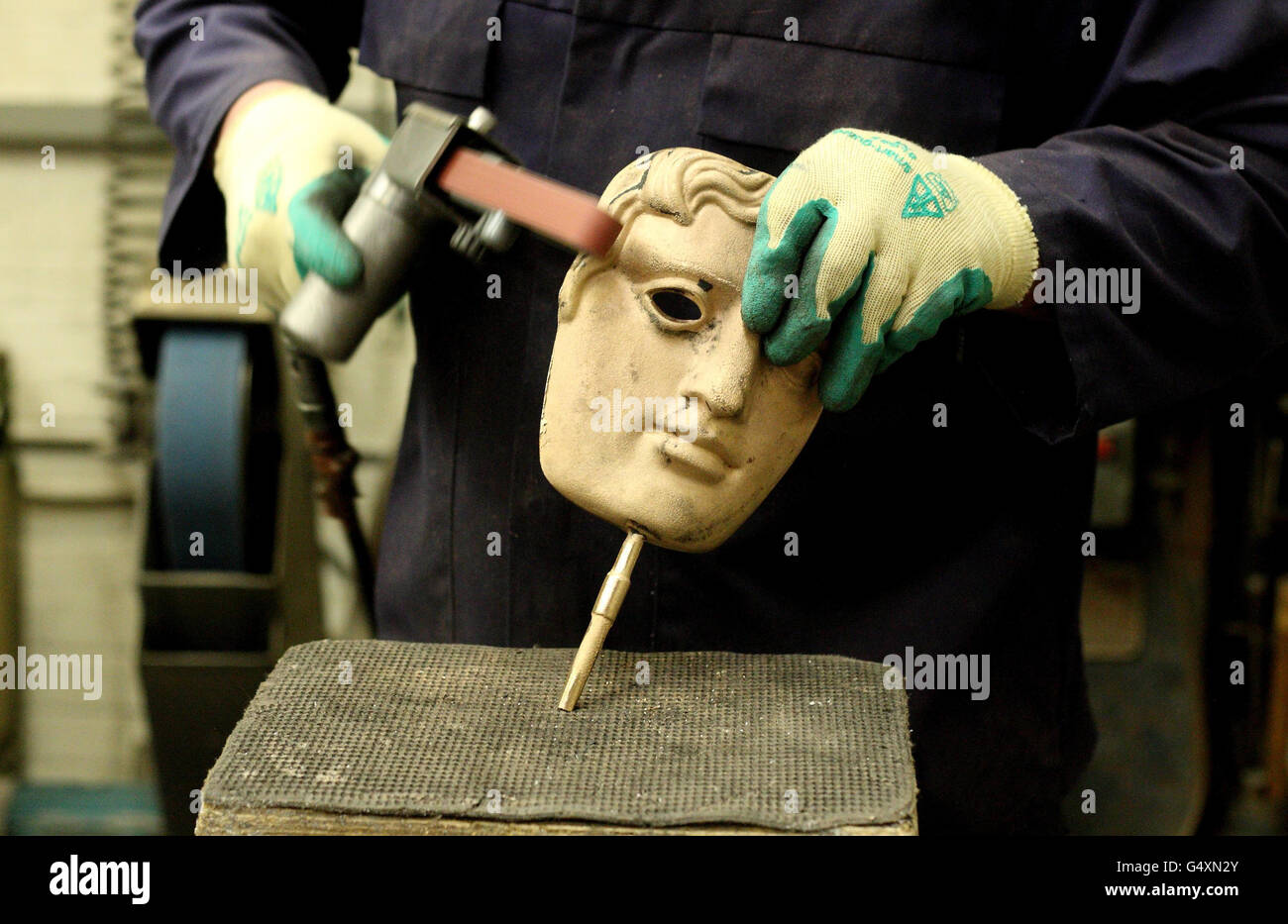 Fettler Piotr Lichon of New Pro Foundries in West Drayton, West London ...