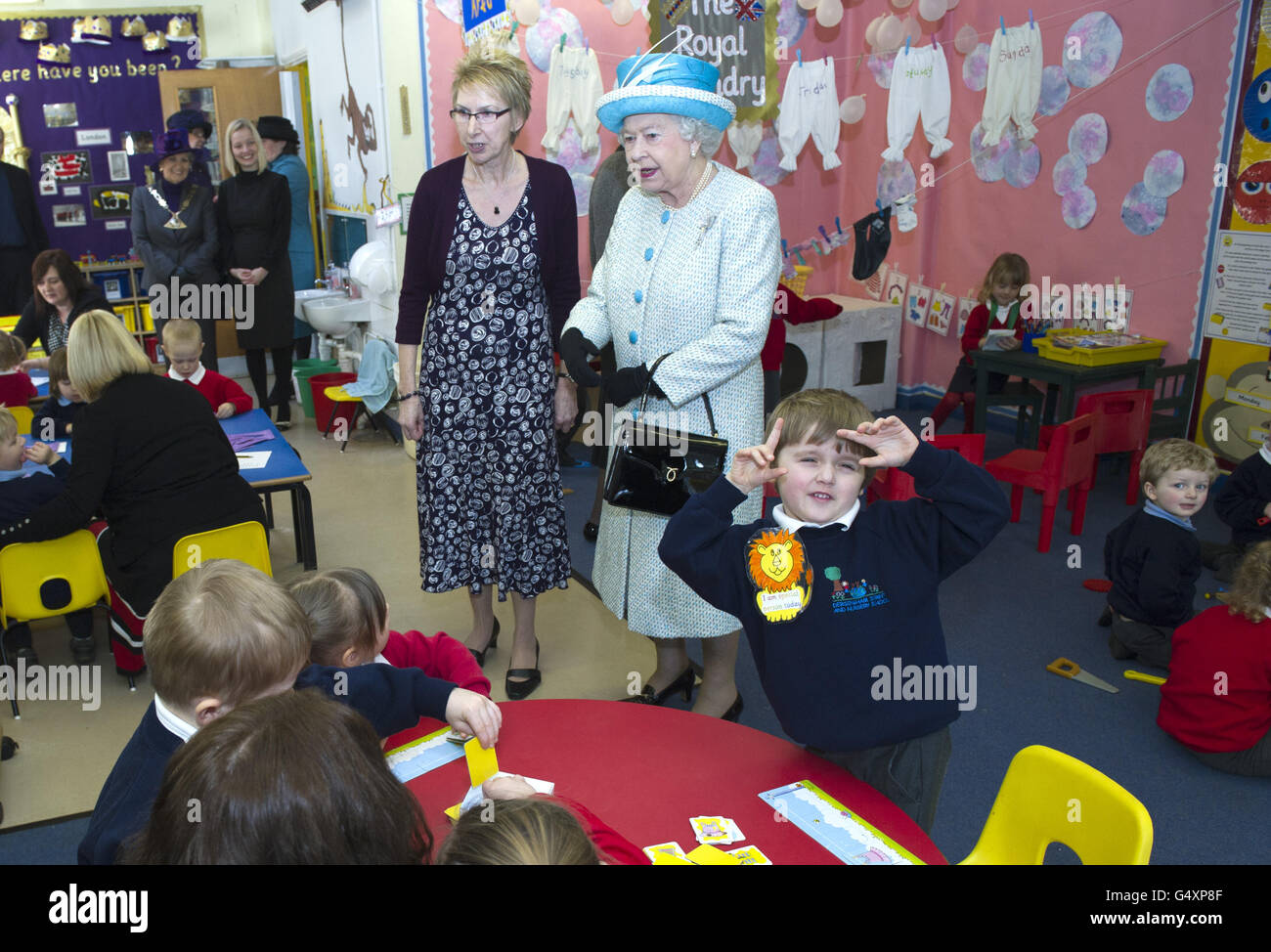 Isaac Minns, three, plays up to the camera as Queen Elizabeth II visits ...