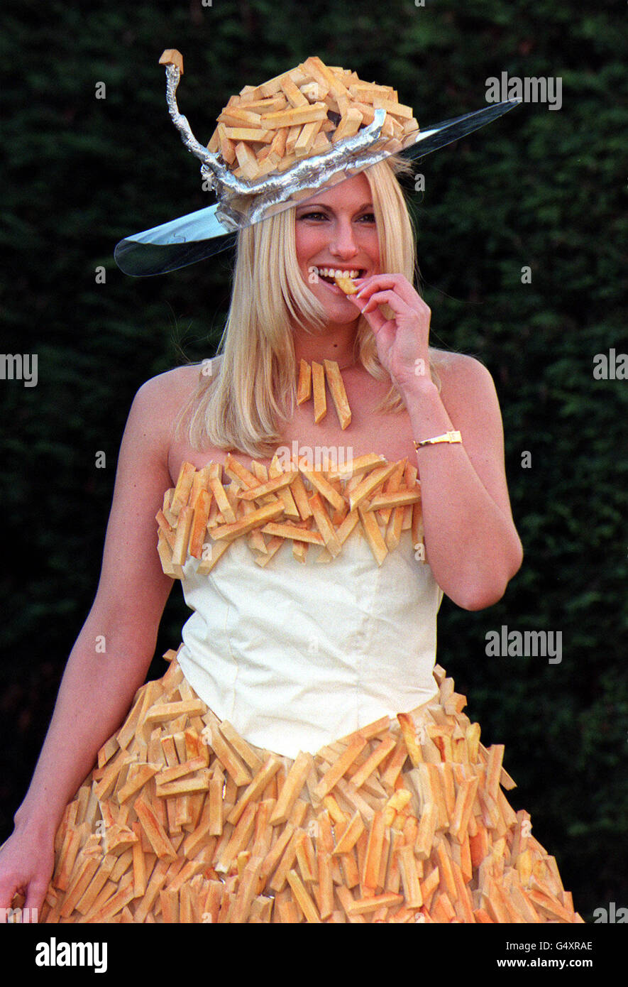 Fashion chips food eating smiling sleeveless dress hat hi-res stock ...