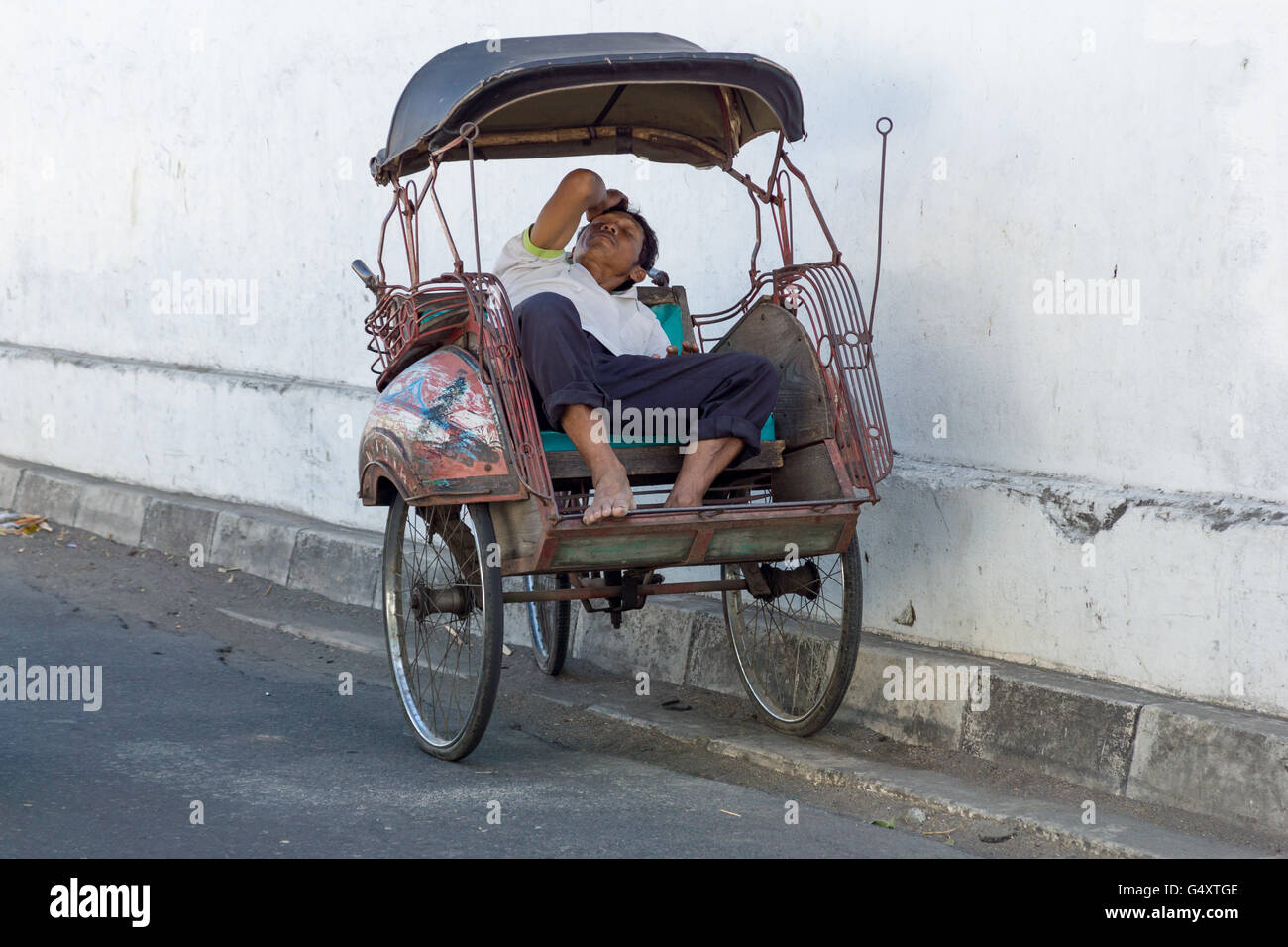 Indonesia, Java, Yogyakarta, street scene - sleeping rickshaw driver ...