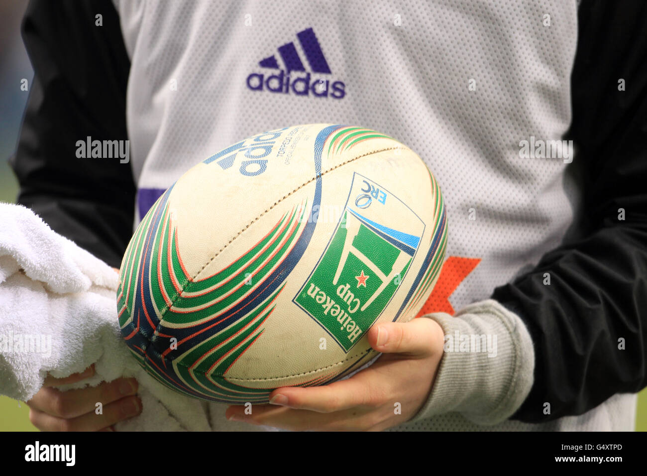 Detail of ballboy holding an official heineken cup rugby matchball hi ...