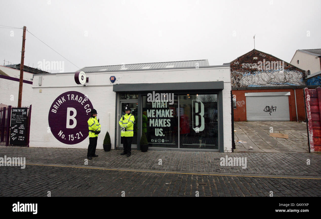 Police stand guard outside The Brink, an alcohol free bar, in Liverpool ...