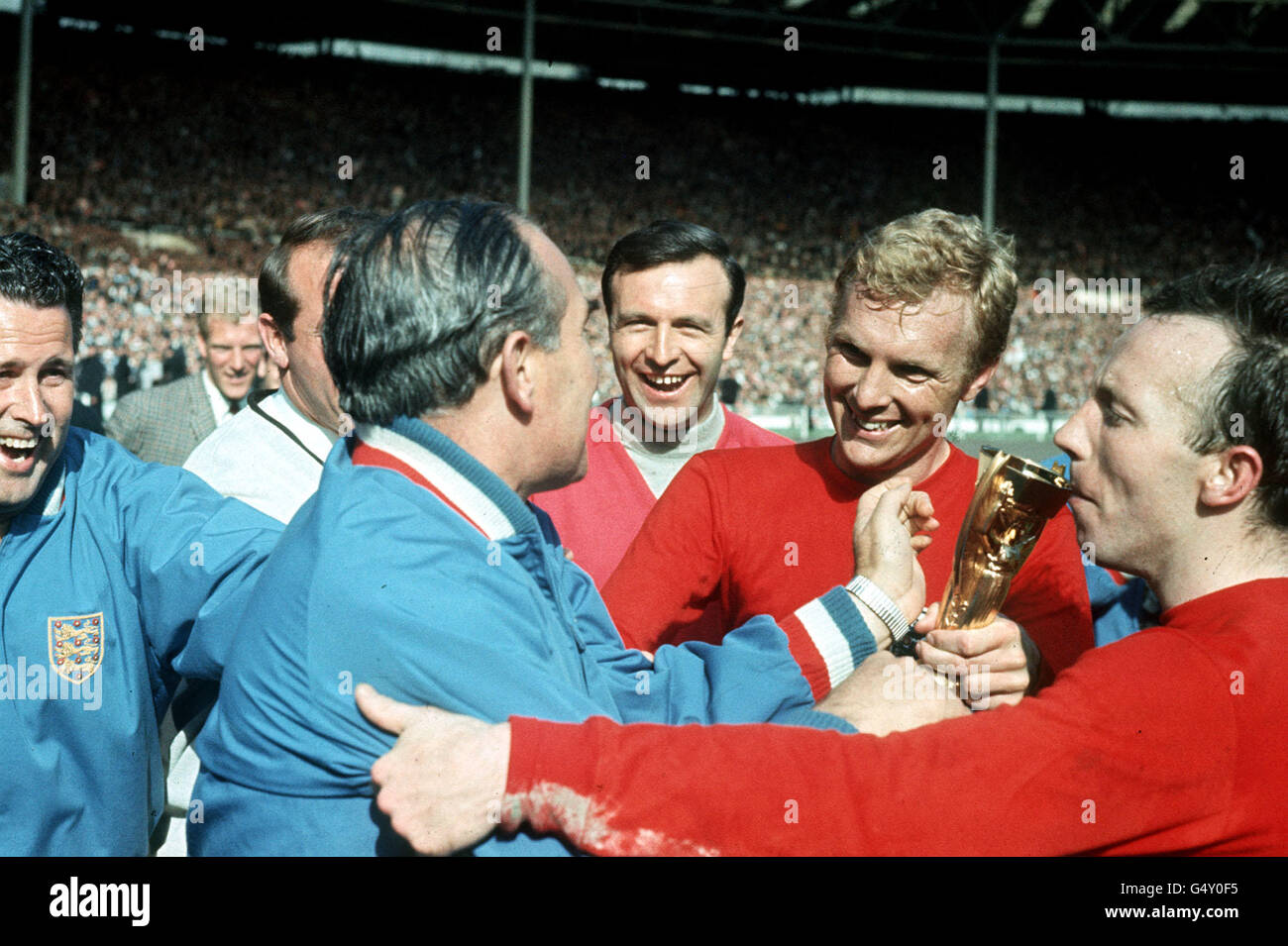 NOBBY STILES KISSES THE TREASURED WORLD CUP TROPHY AS BOBBY MOORE (C ...