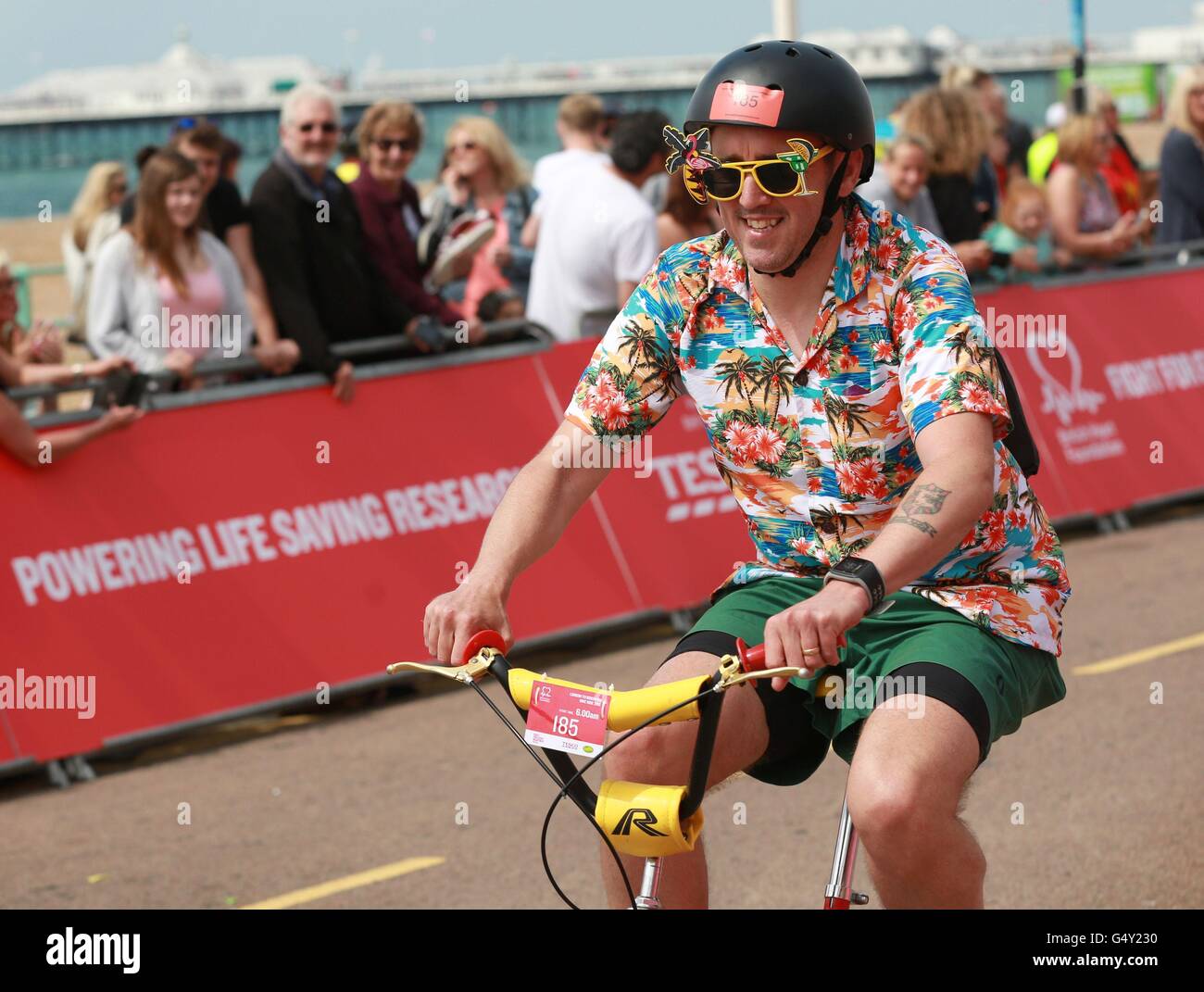 EDITORIAL USE ONLY Cyclists cross the finishing line in Brighton after ...