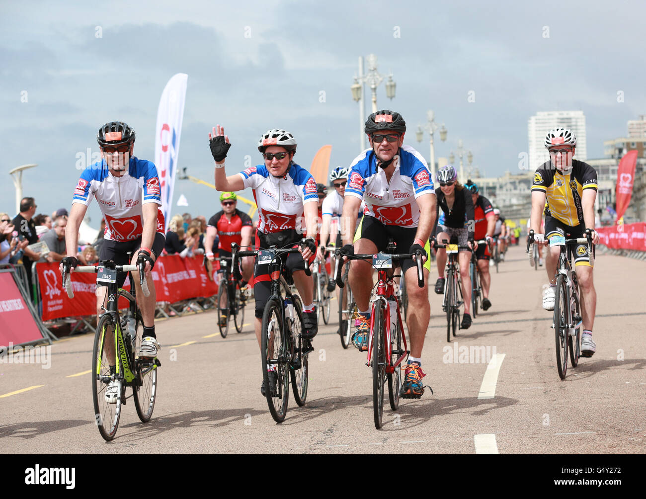 EDITORIAL USE ONLY Cyclists cross the finishing line in Brighton after ...