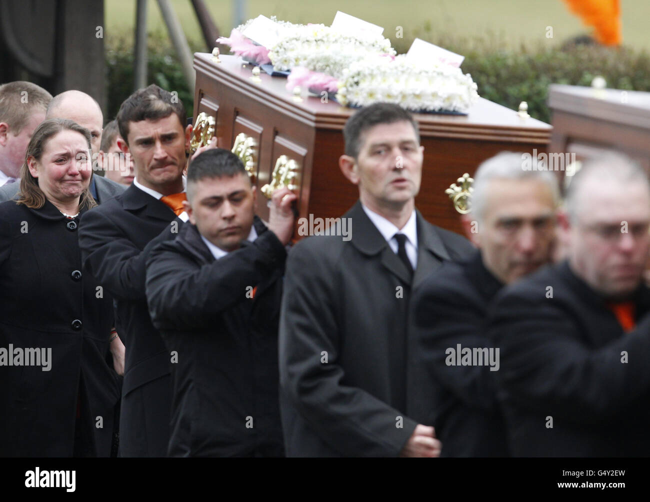 Michelle Smith (left) walks behind the two coffins of her four children ...