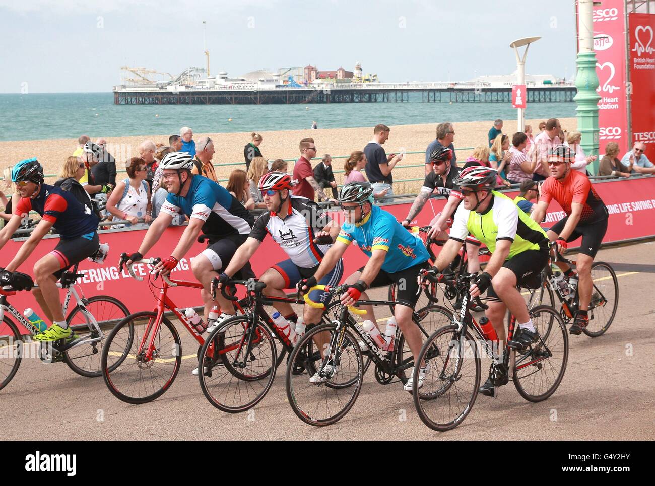 EDITORIAL USE ONLY Cyclists cross the finishing line in Brighton after ...