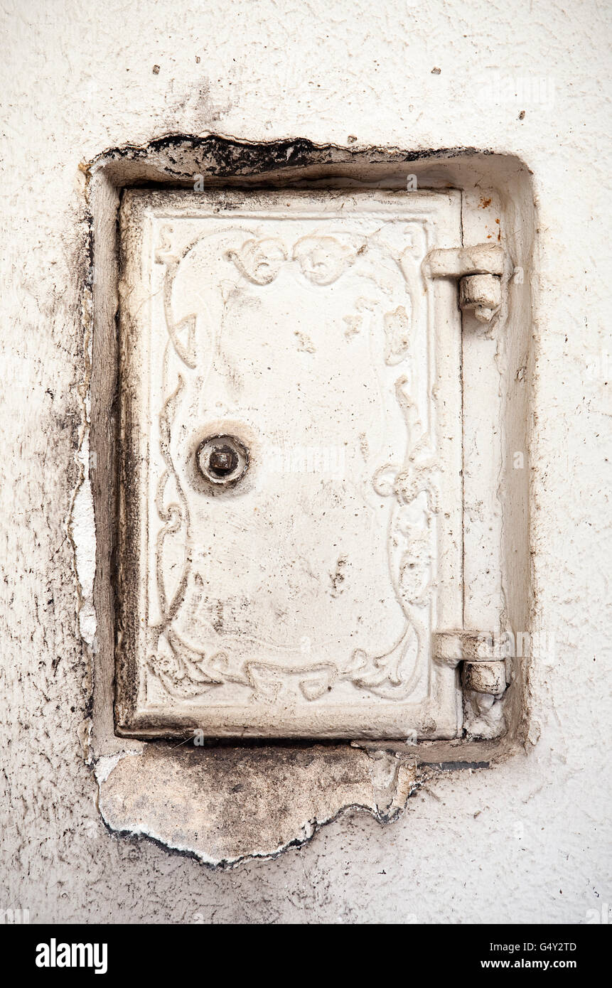 old retro furnace door, painted white, inside chimney indoor, with ...