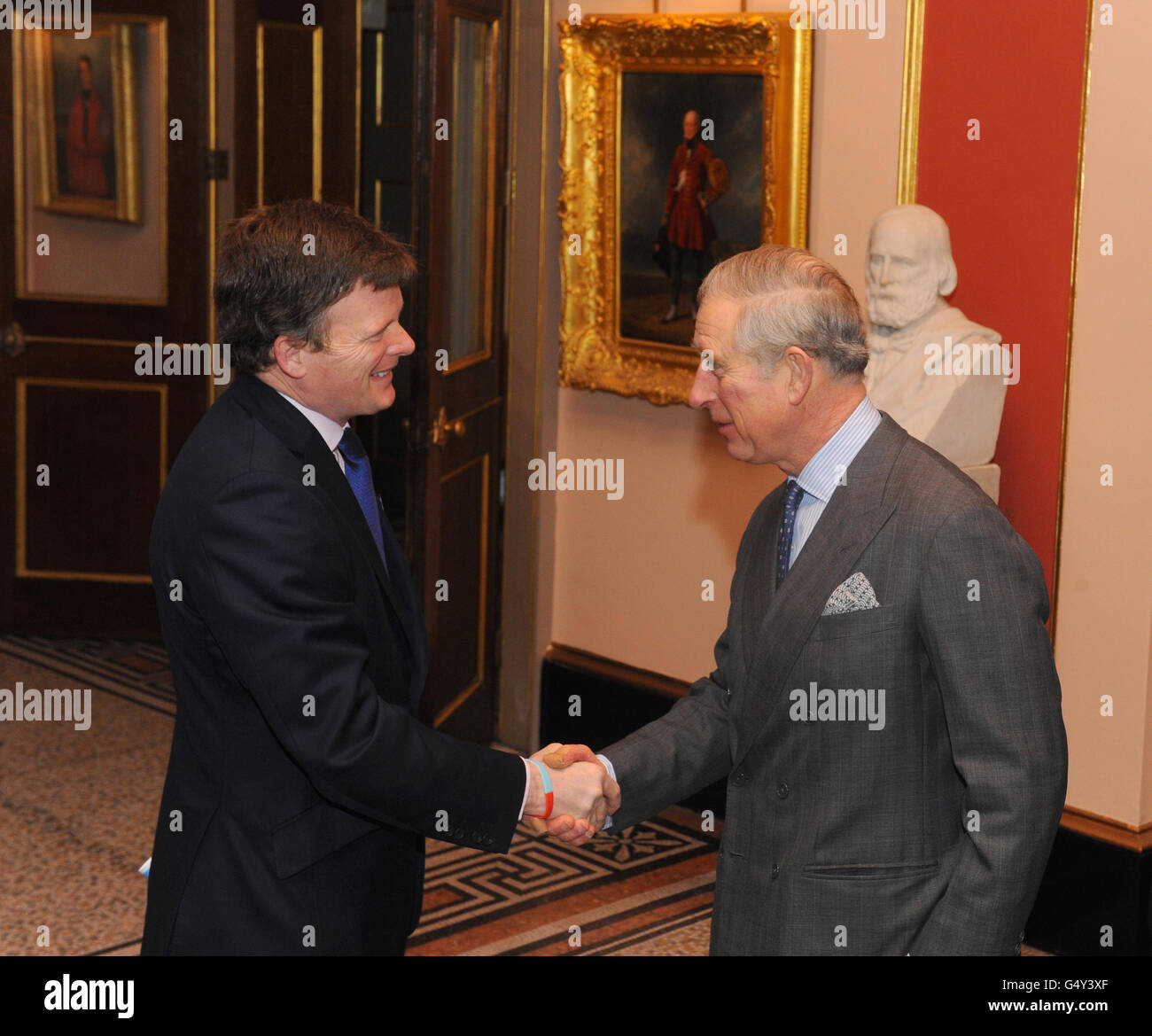 The Prince of Wales (right) is greeted by Parliamentary Under-Secretary ...