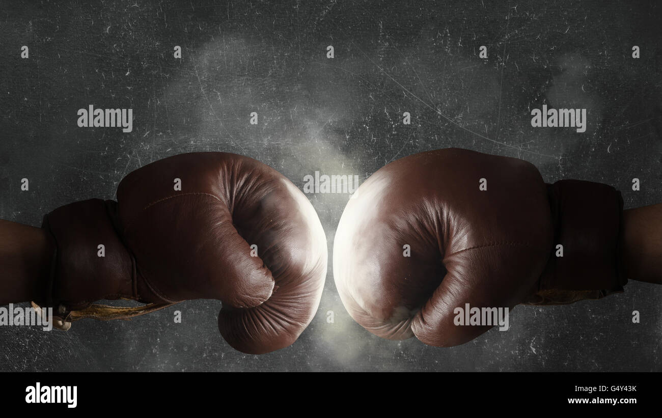 Two brown old boxing gloves hit together Stock Photo - Alamy