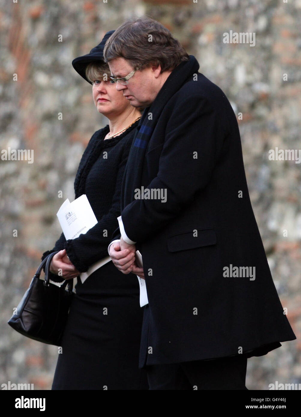 Lady Runcie's son James and daughter Rebecca, follow her coffin as it ...