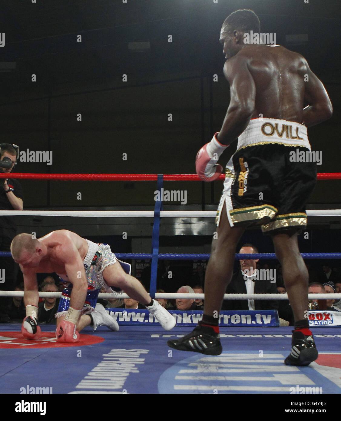 Ovill McKenzie stands over Tony Dodson after knocking him down during ...