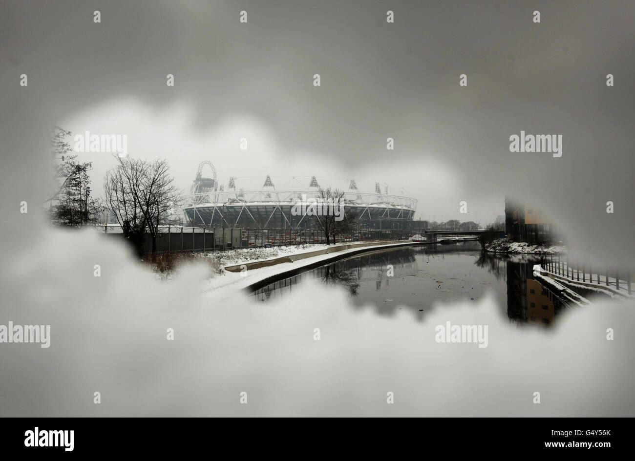 A general view through snow of the Olympic Stadium in Stratford, east ...