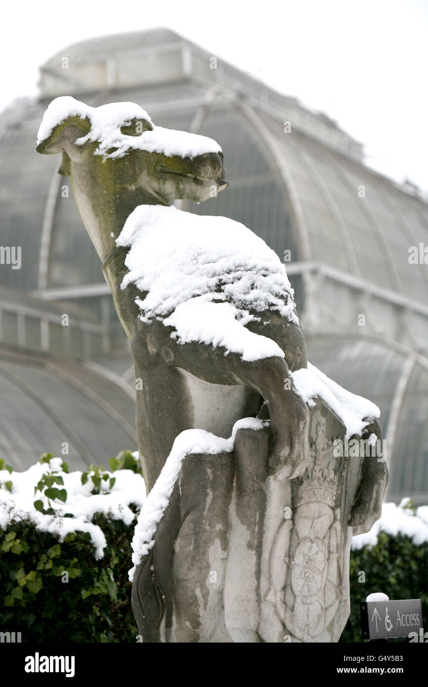A snow-covered statue stands guard over the Palm House in the Royal ...