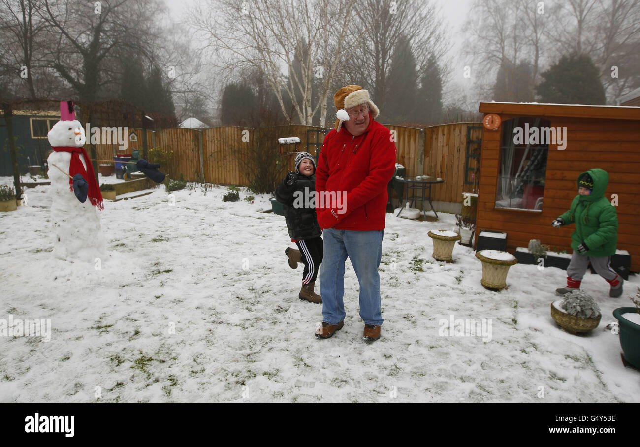 Graham Thompson plays in the snow with his grandchildren George (left ...