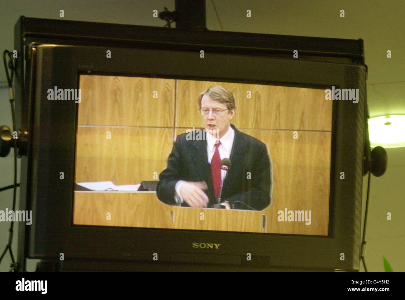 Alun Michael being broadcast on a television screen at the Assembly ...