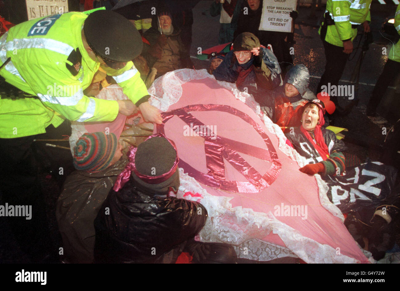 Anti-nuclear protesters sit down with their arms linked together inside ...