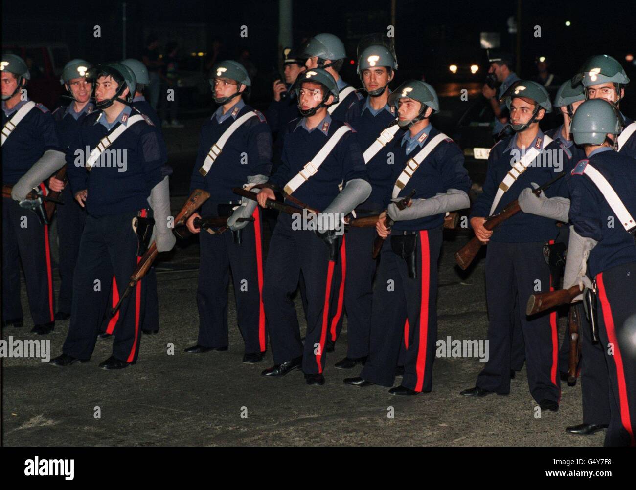 FOOTBALL HOOLIGANS, POLIZIA WITH GUNS FORM A LINE TO CONTROL FANS IN ...
