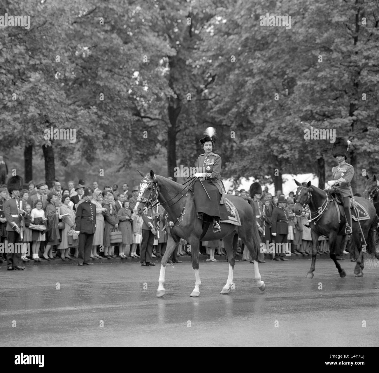 Queen Elizabeth II, riding her police horse 'Imperial', on her way down ...