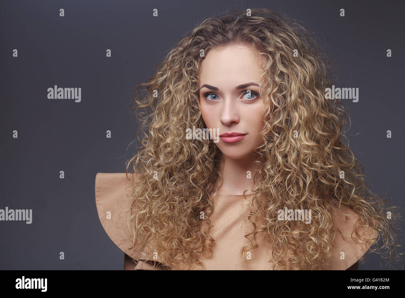 Portrait of perfect woman with curly hair Stock Photo - Alamy